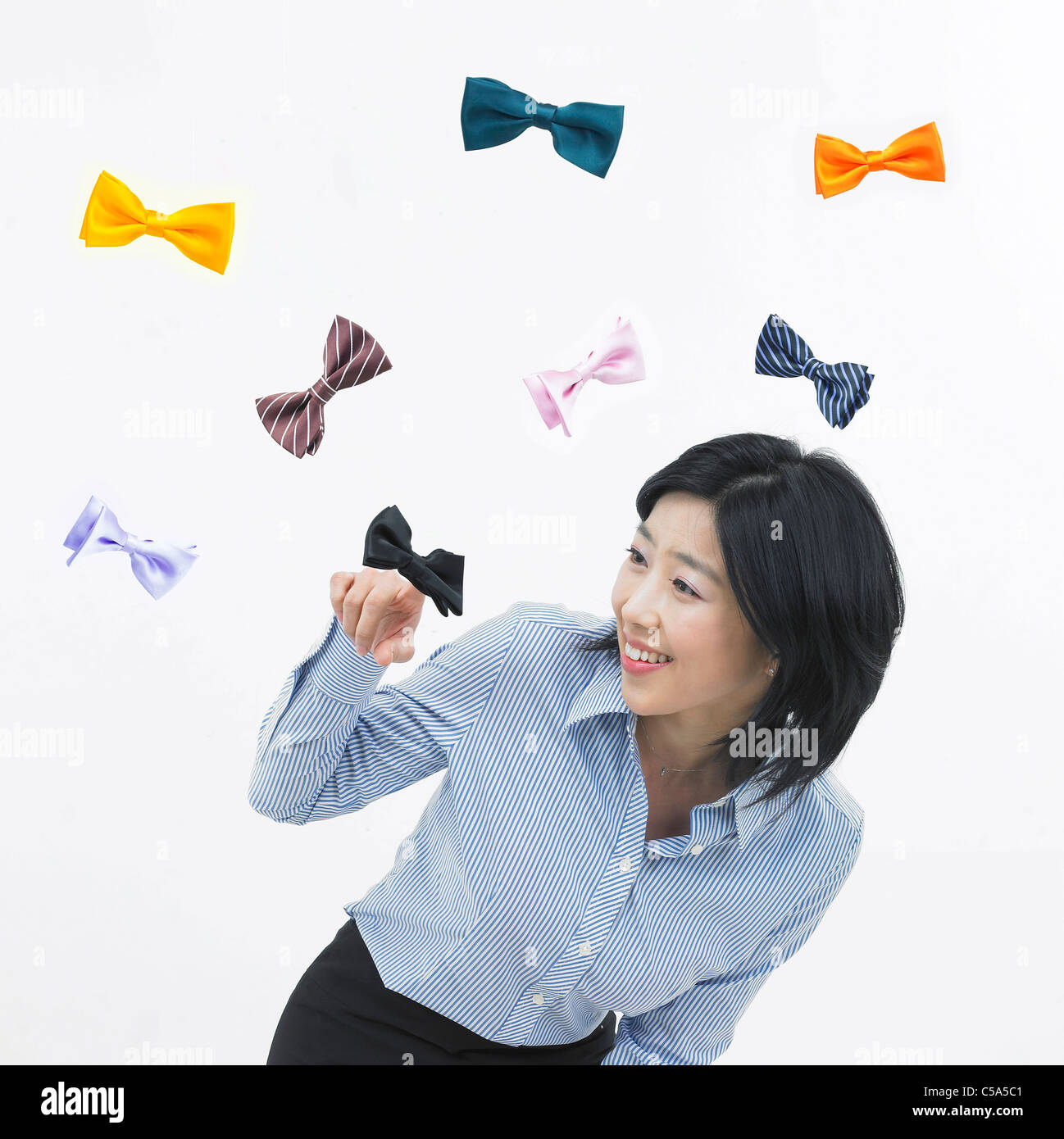 Close-up of young woman touching bow Stock Photo - Alamy