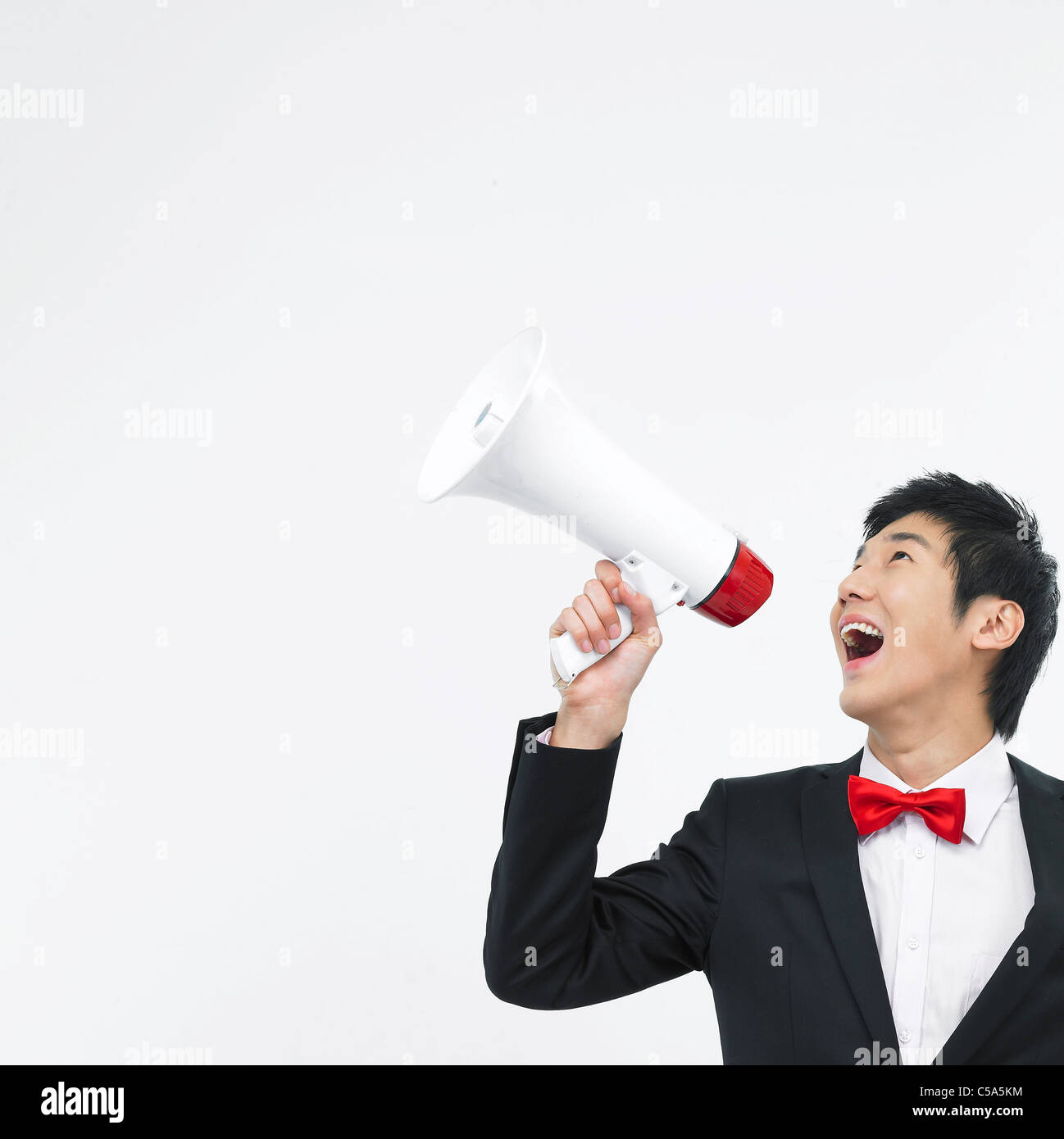 Young man holding megaphone Stock Photo - Alamy