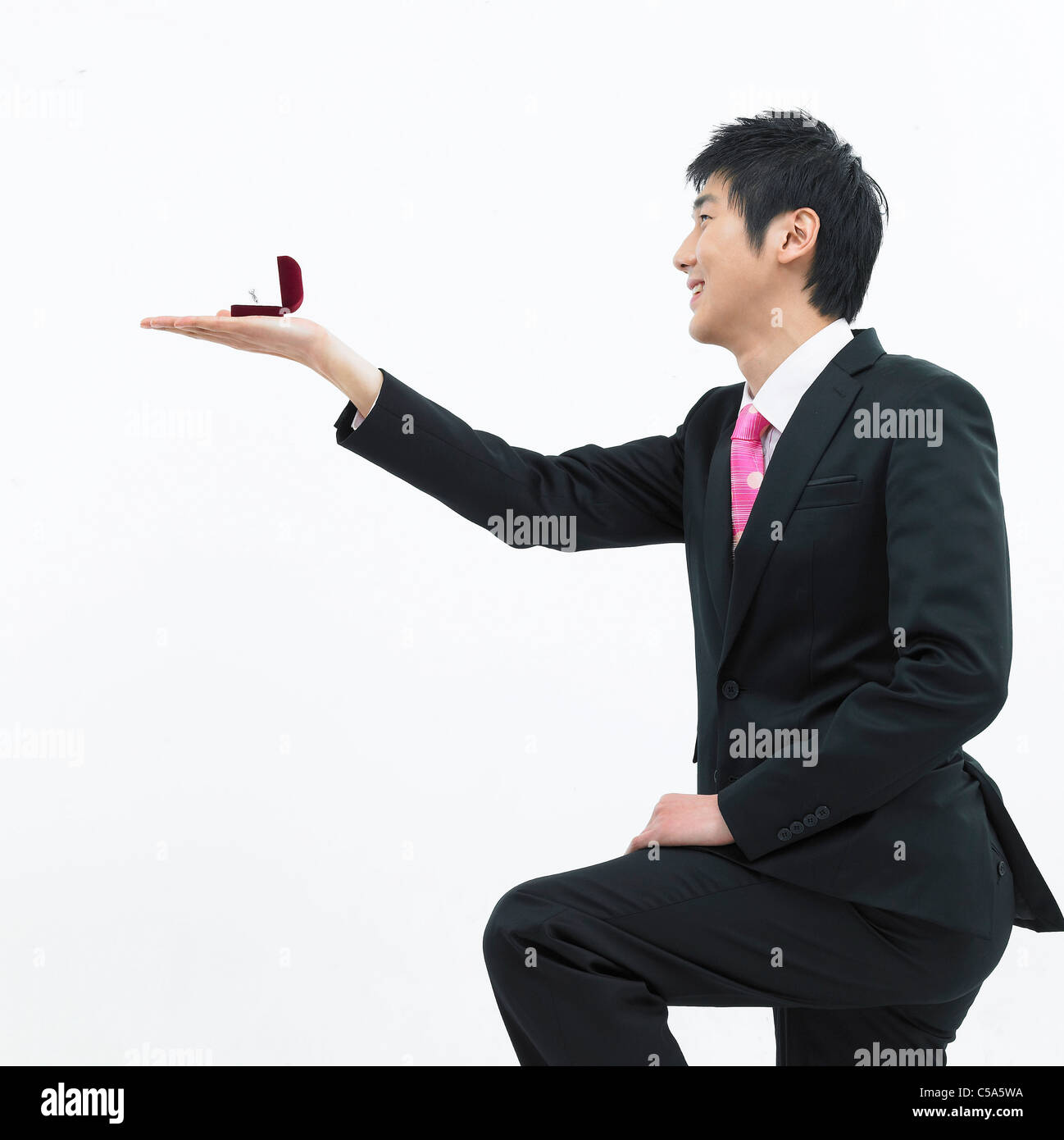 Portrait of young man holding ring Stock Photo - Alamy