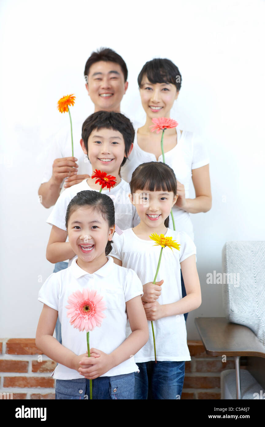 Portrait of family holding flowers Stock Photo - Alamy