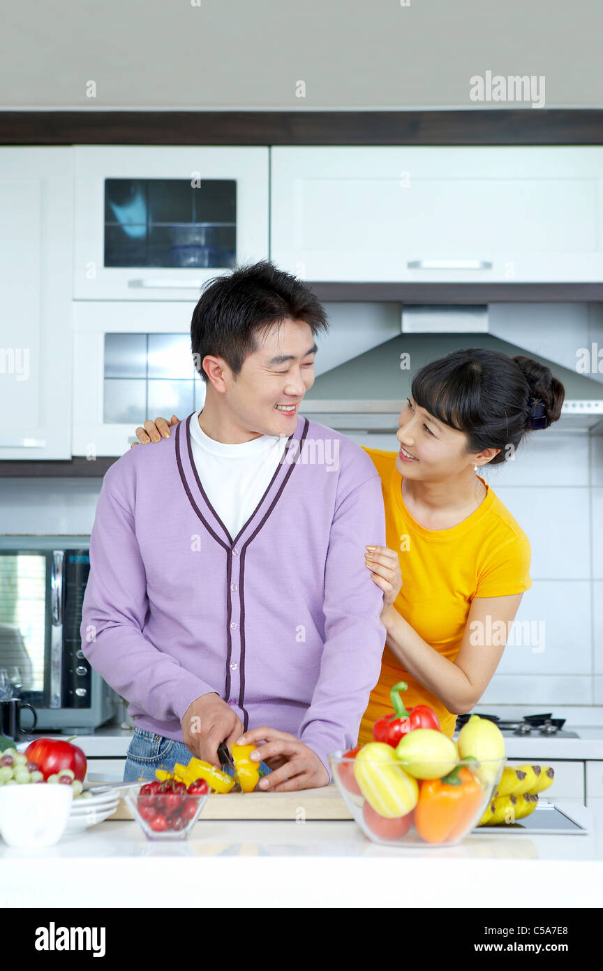 Husband and wife cooking in kitchen Stock Photo - Alamy