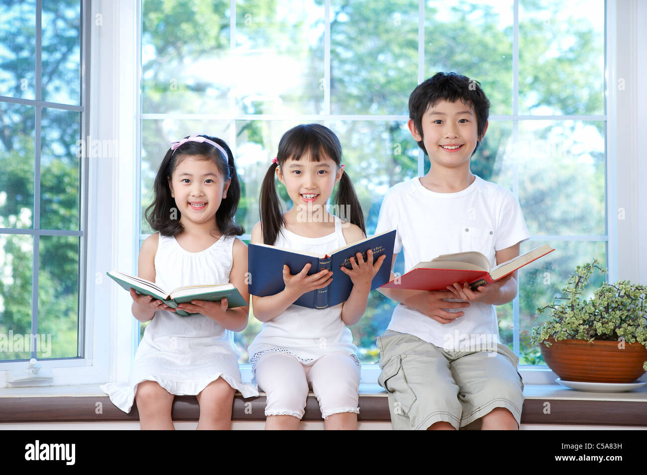 Portrait of children reading book Stock Photo - Alamy