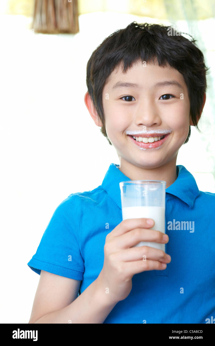 Portrait of boy holding milk glass Stock Photo - Alamy