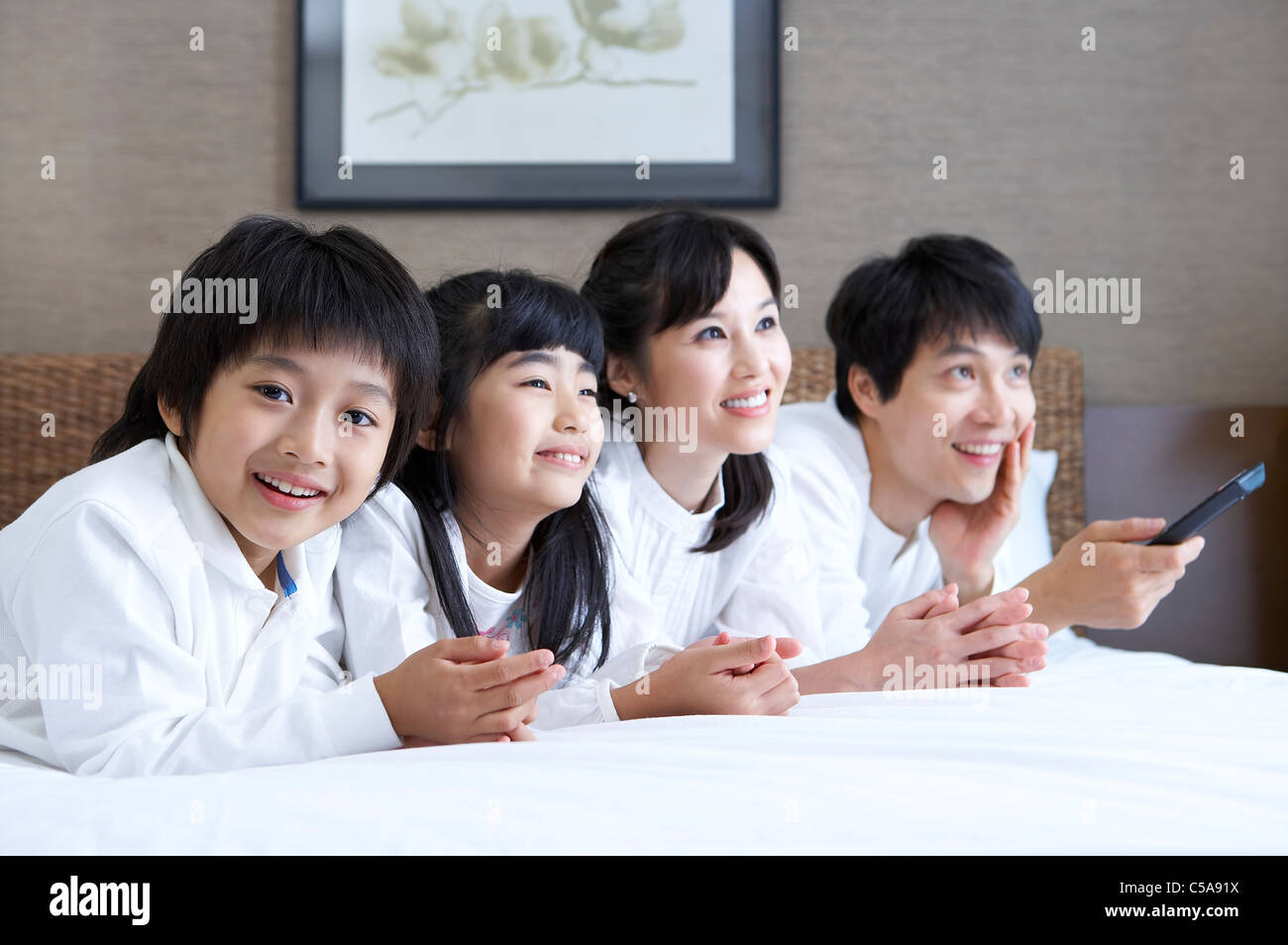 Side view of family on a bed Stock Photo - Alamy