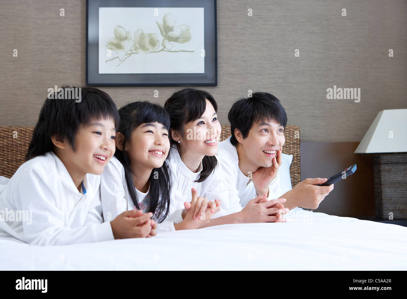 Side view of family on a bed Stock Photo - Alamy