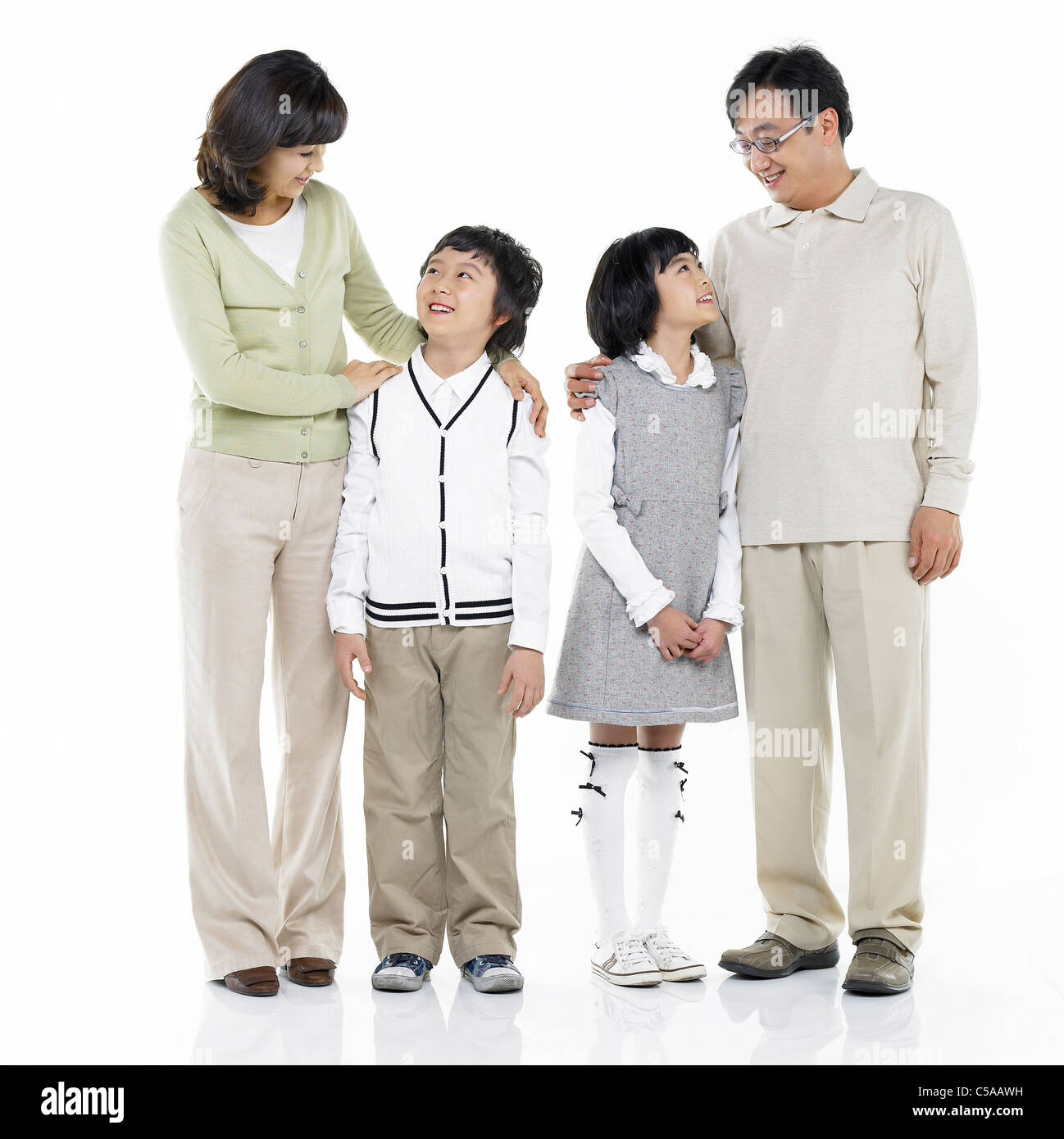 Parents standing with children Stock Photo - Alamy