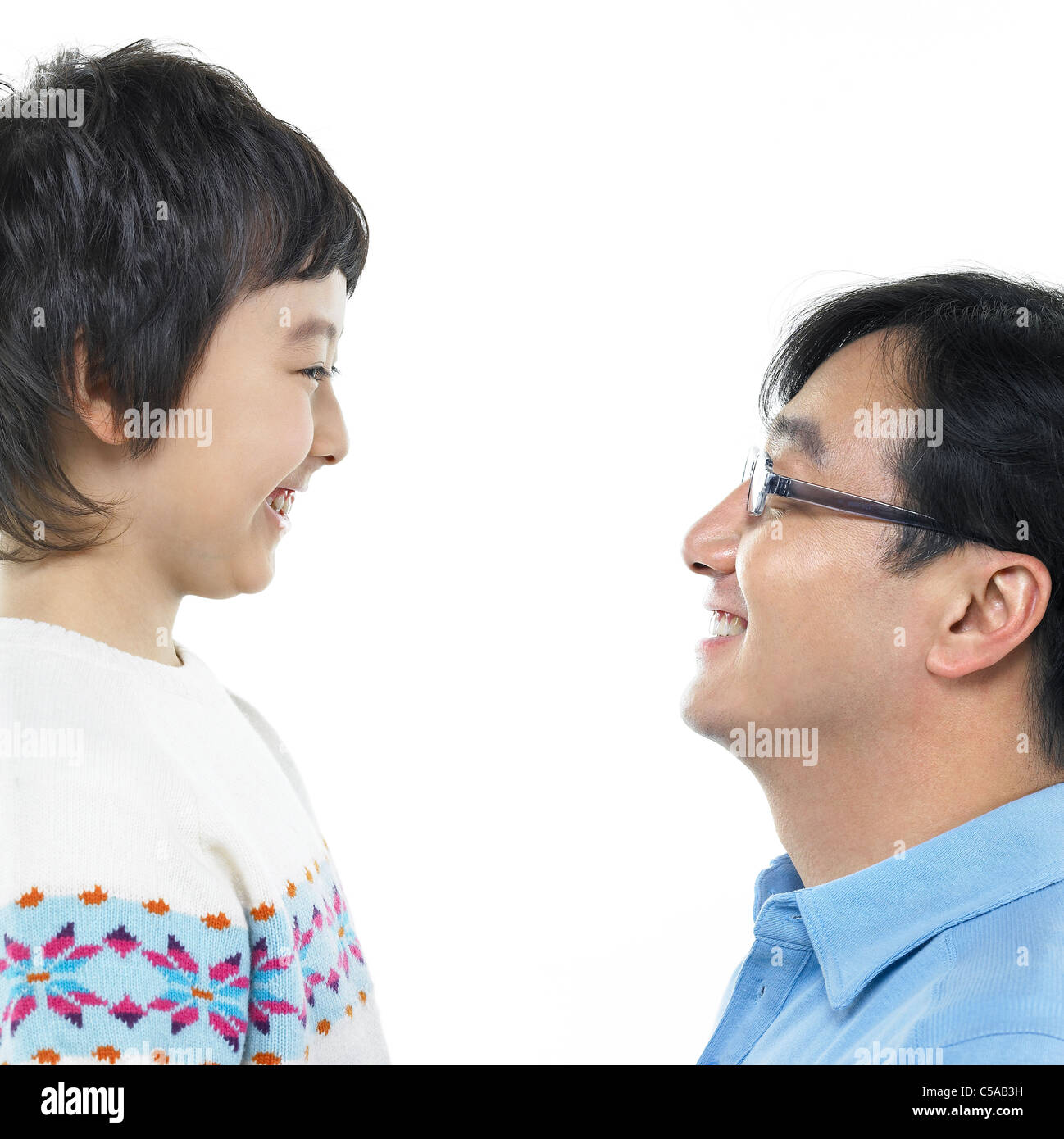 Side view of father and son smiling Stock Photo - Alamy
