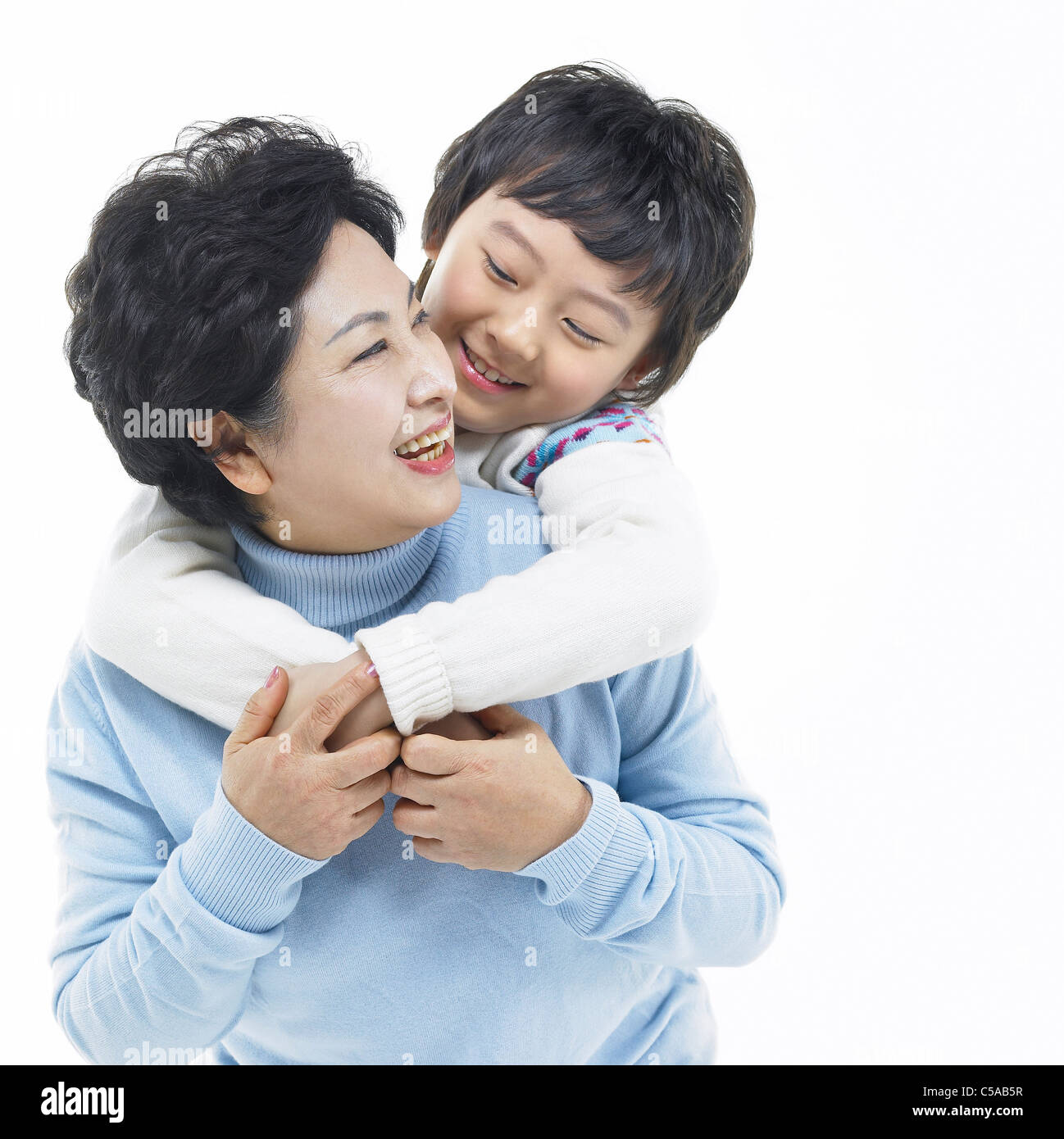 Grandson hugging grandmother Stock Photo - Alamy