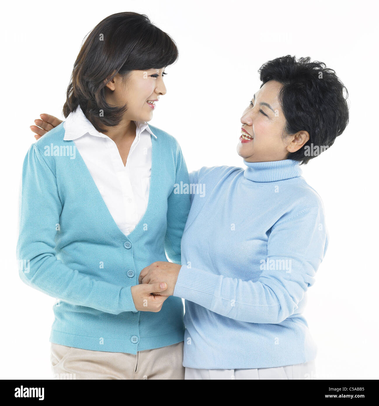 Side view of mature woman and daughter in law smiling Stock Photo - Alamy