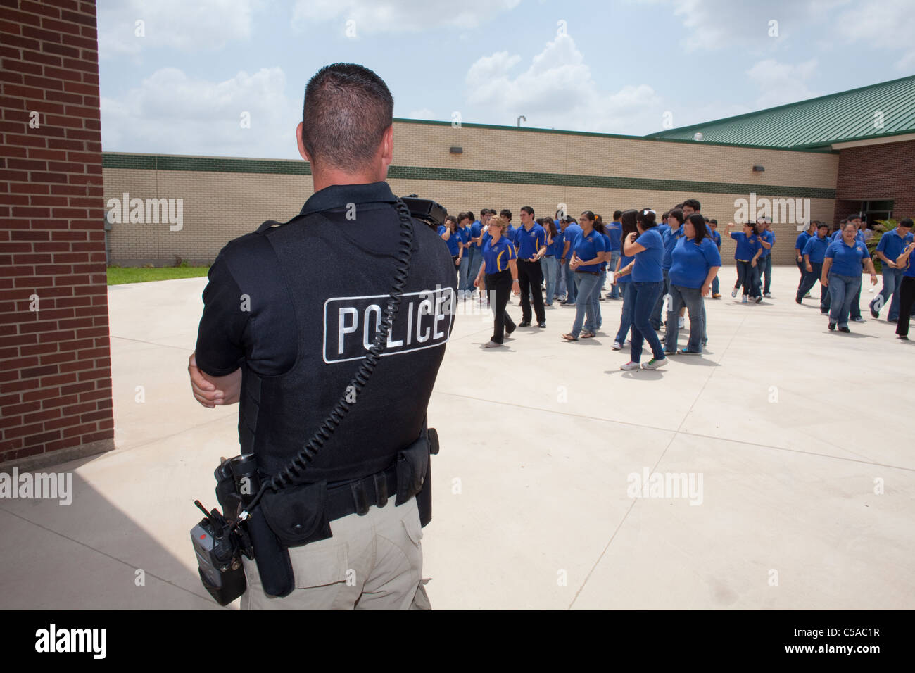 Male police officers supervise and keep an eye on students in South ...