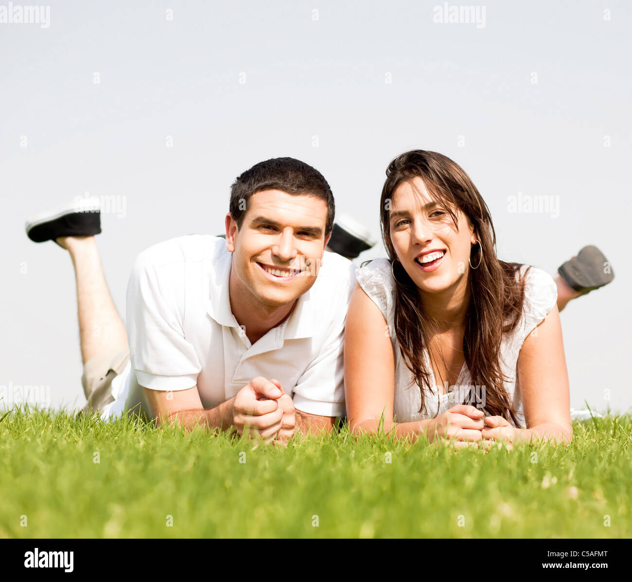 love Couple lie down on grass Together Outside and smile Stock Photo ...