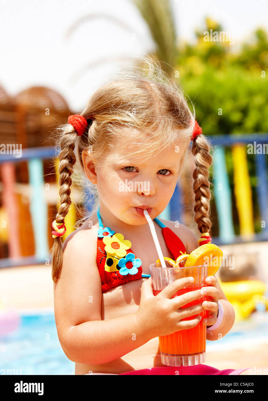 Child in red bikini on playground outdoor Stock Photo - Alamy