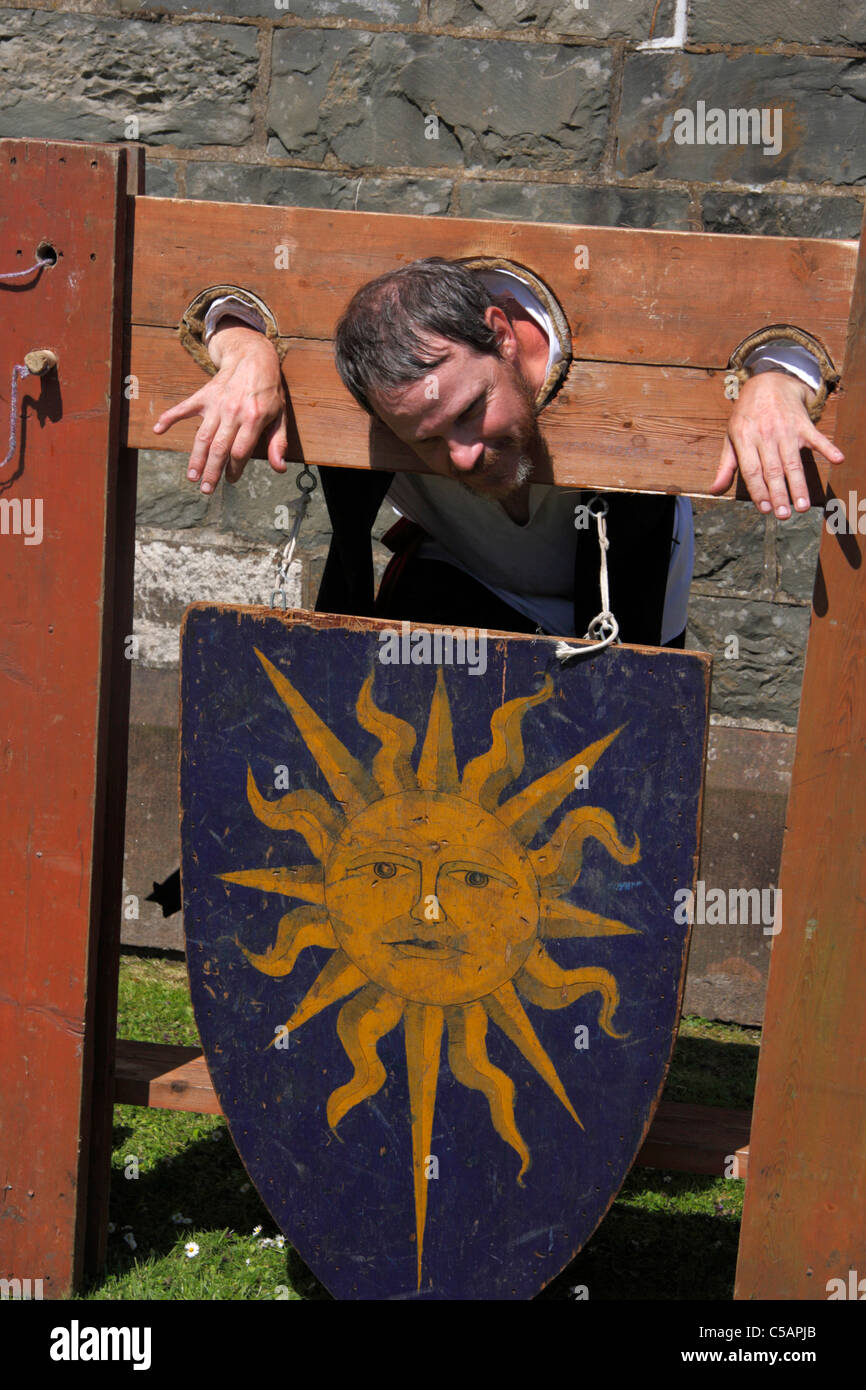 Man in medieval costume in stocks Stock Photo - Alamy