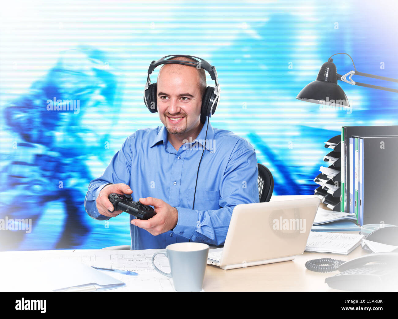 man in office play with videogame console Stock Photo - Alamy