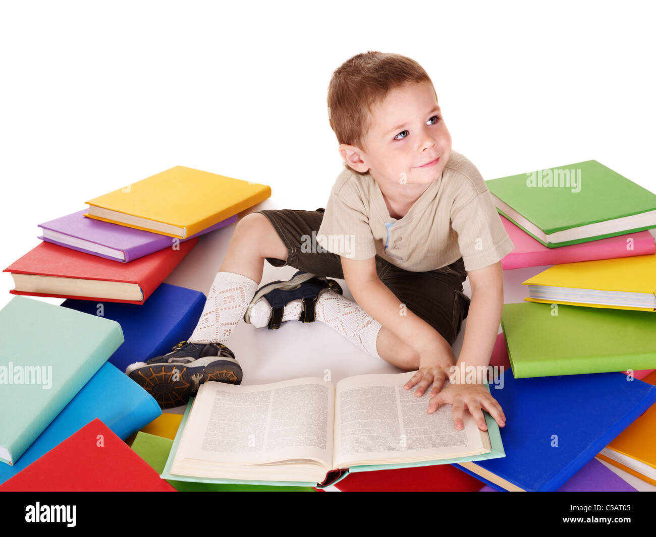 Little boy reading pile of books Stock Photo - Alamy