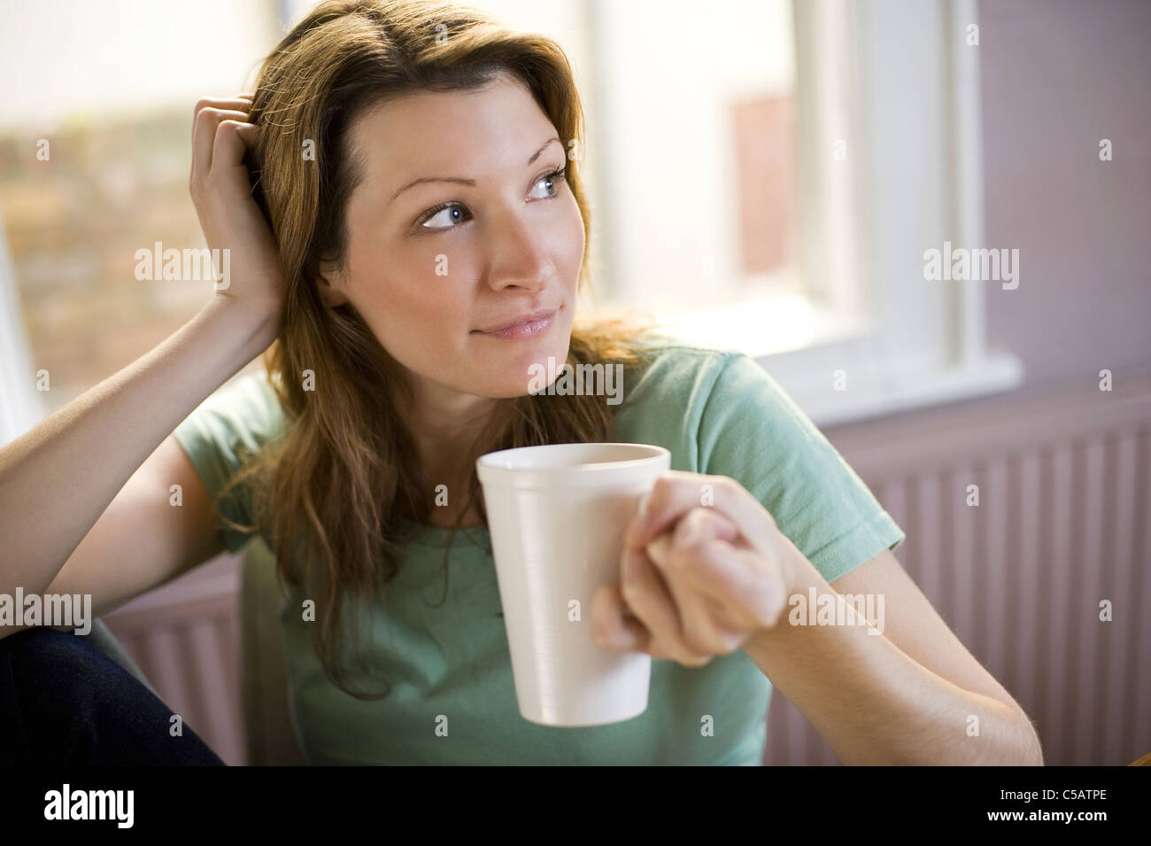 woman drinking tea in a kitchen Stock Photo - Alamy