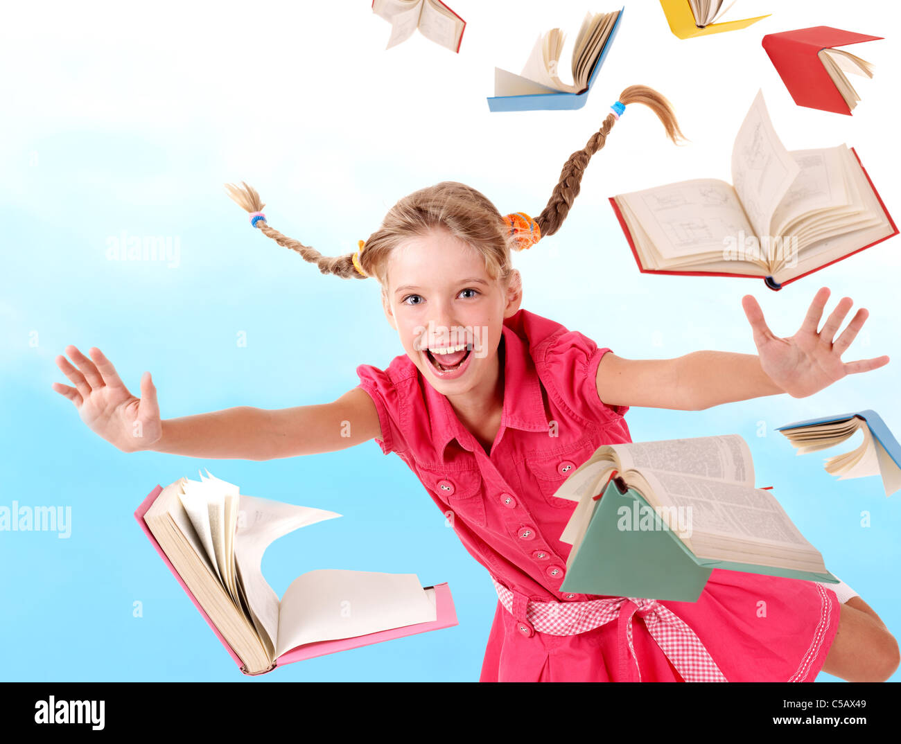 Child with books. Little girl and flying books Stock Photo - Alamy