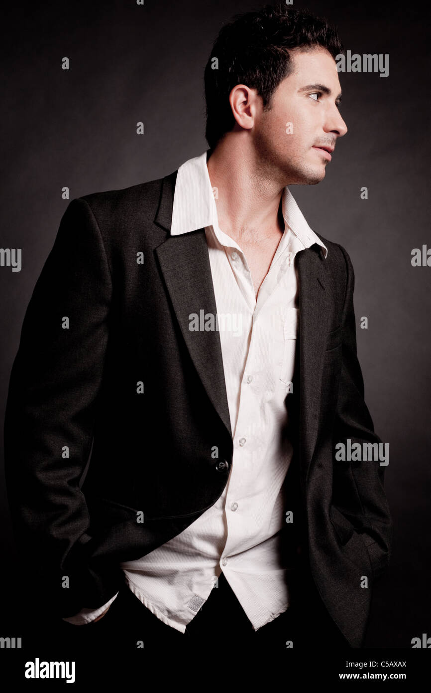 Attractive young man side view,indoor studio Stock Photo - Alamy