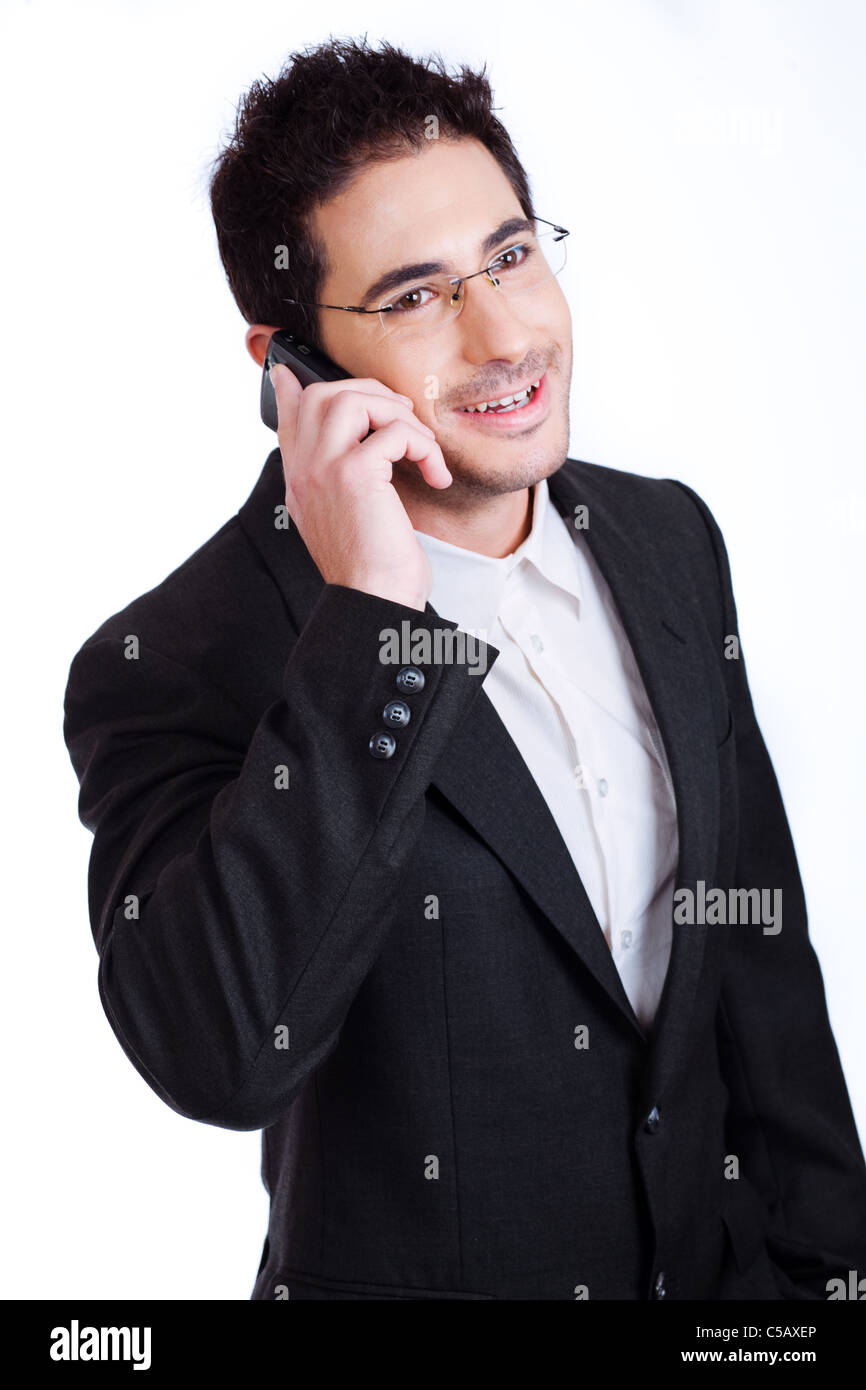 Handsome young business man talking over phone on white isolated ...