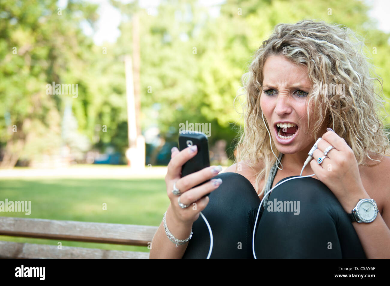 Angry - woman with cellphone Stock Photo - Alamy