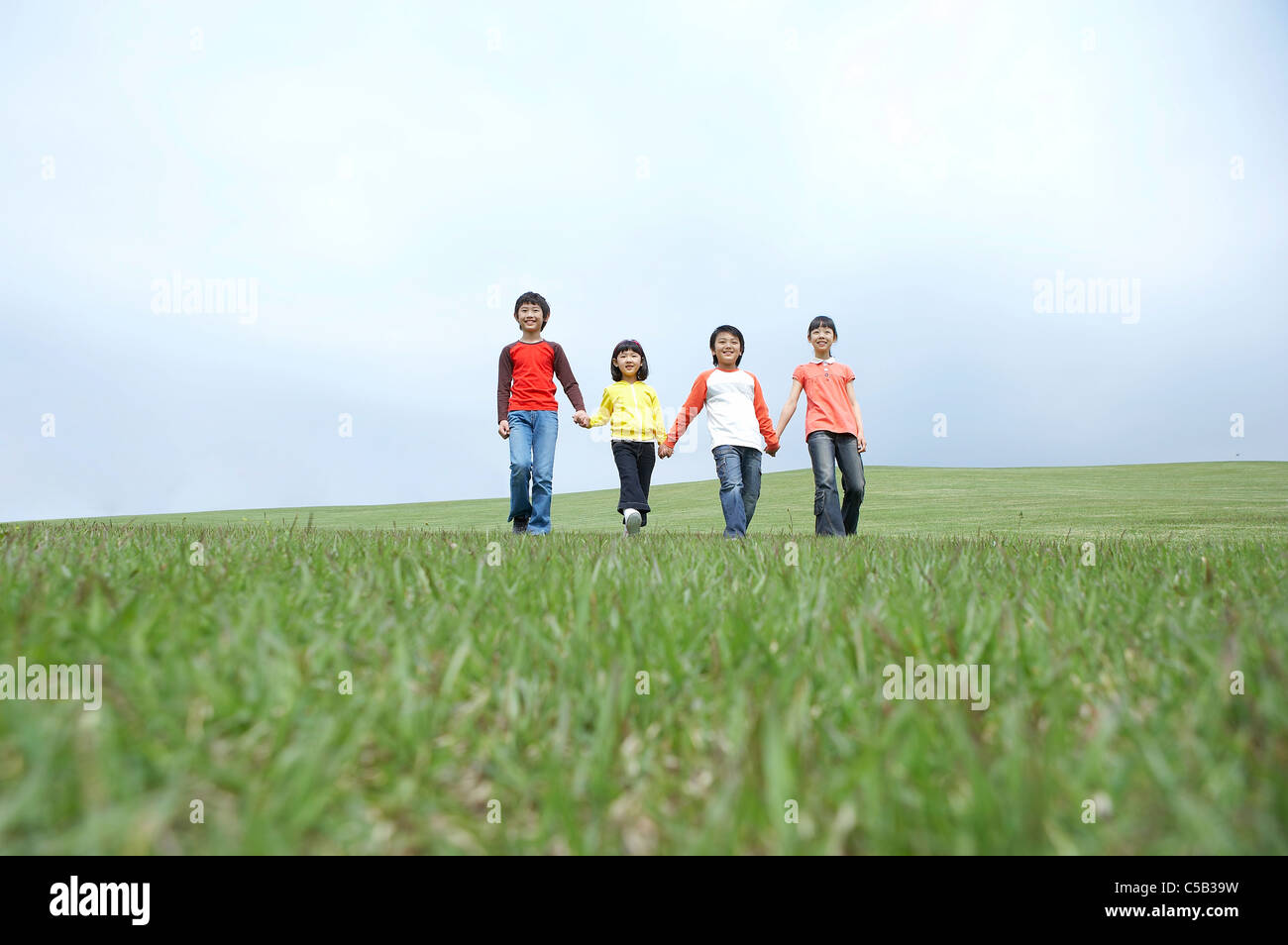 Children walking in lawn Stock Photo - Alamy