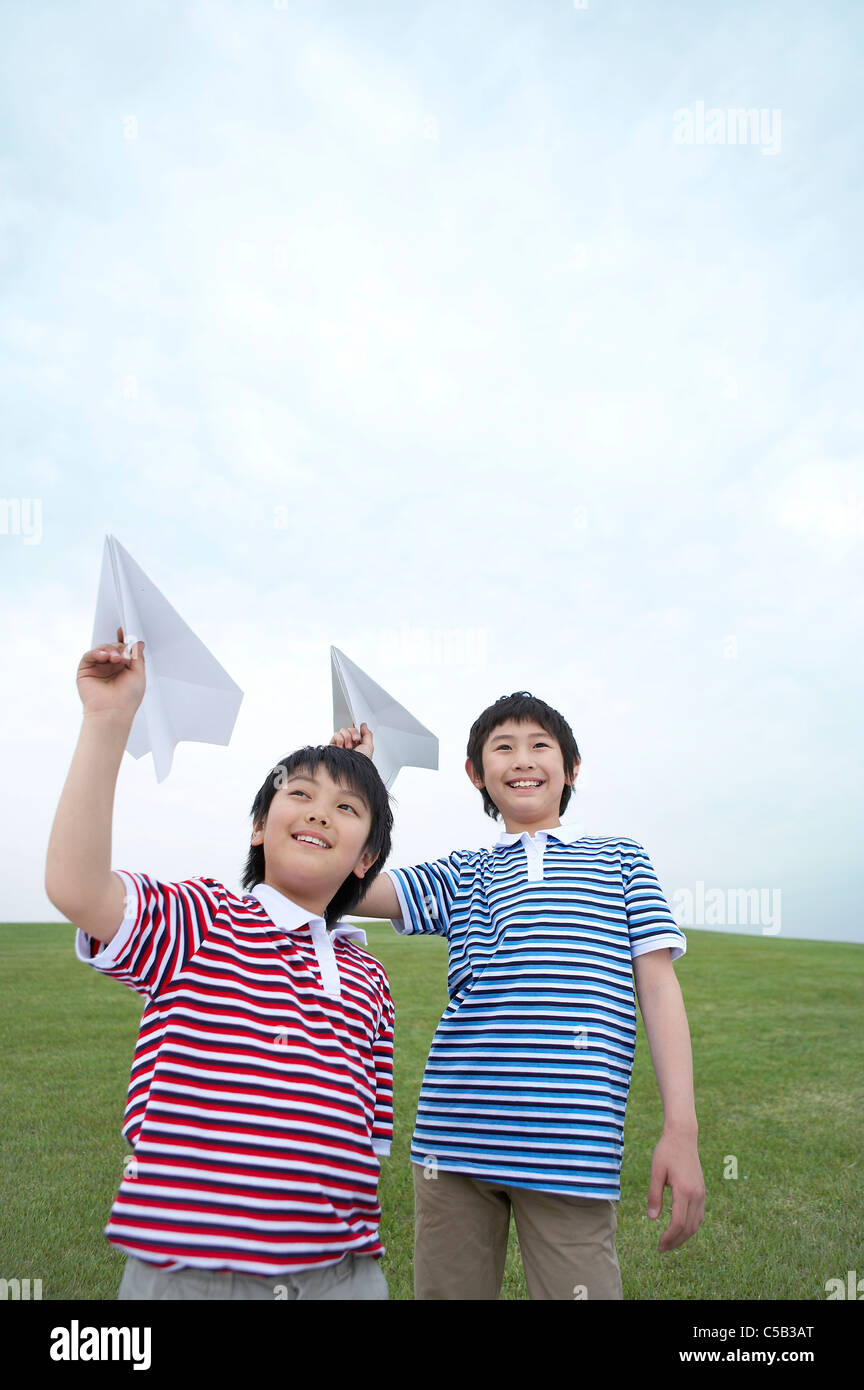Boys flying paper planes Stock Photo - Alamy