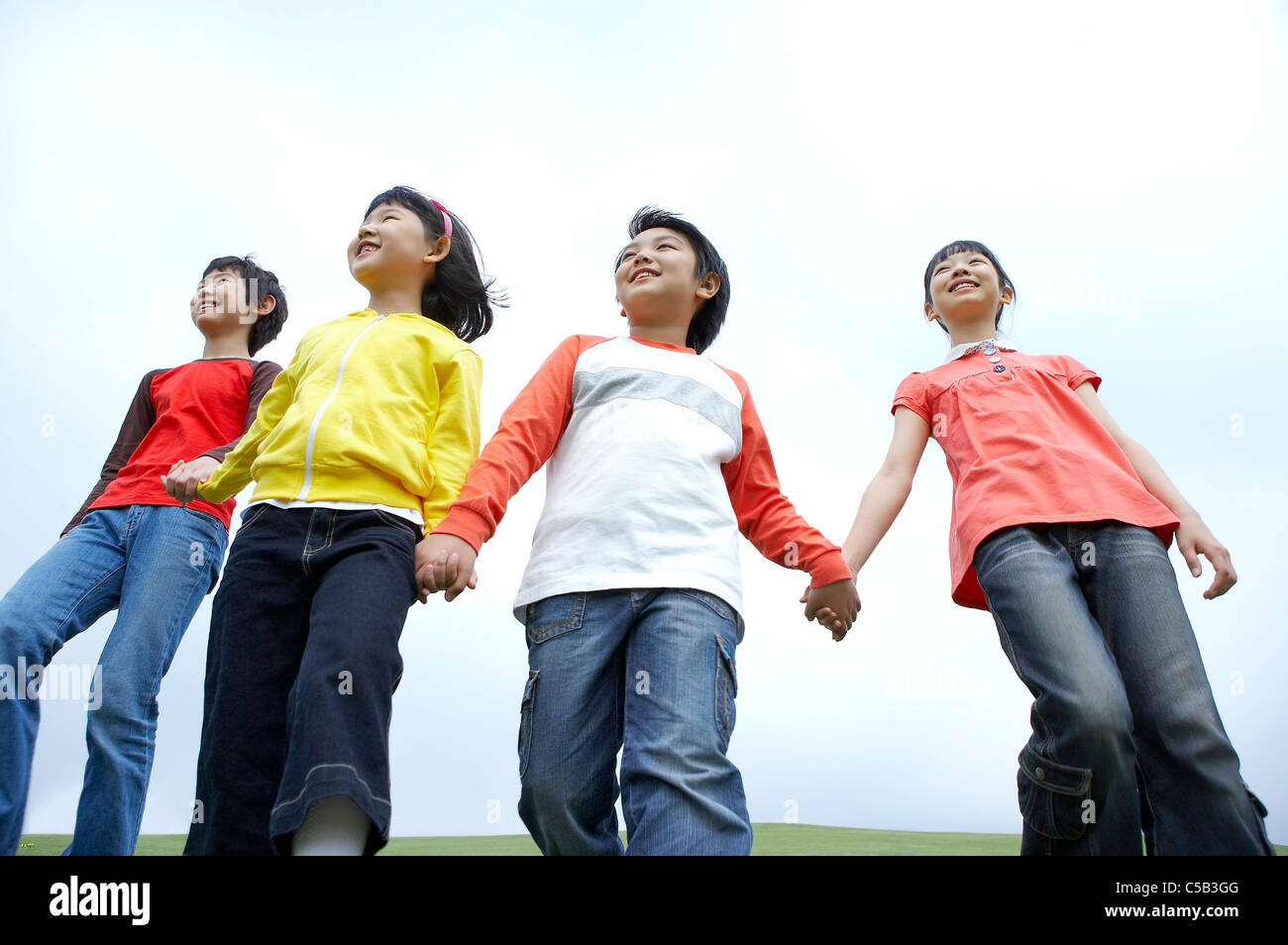 Low angle view of children walking in lawn Stock Photo - Alamy