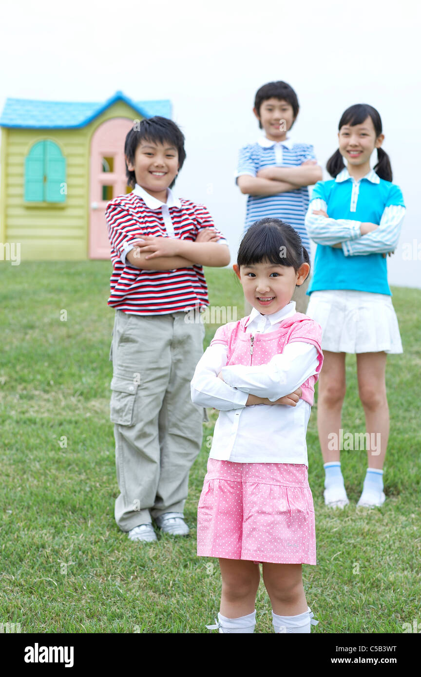 Portrait of children standing in lawn Stock Photo - Alamy