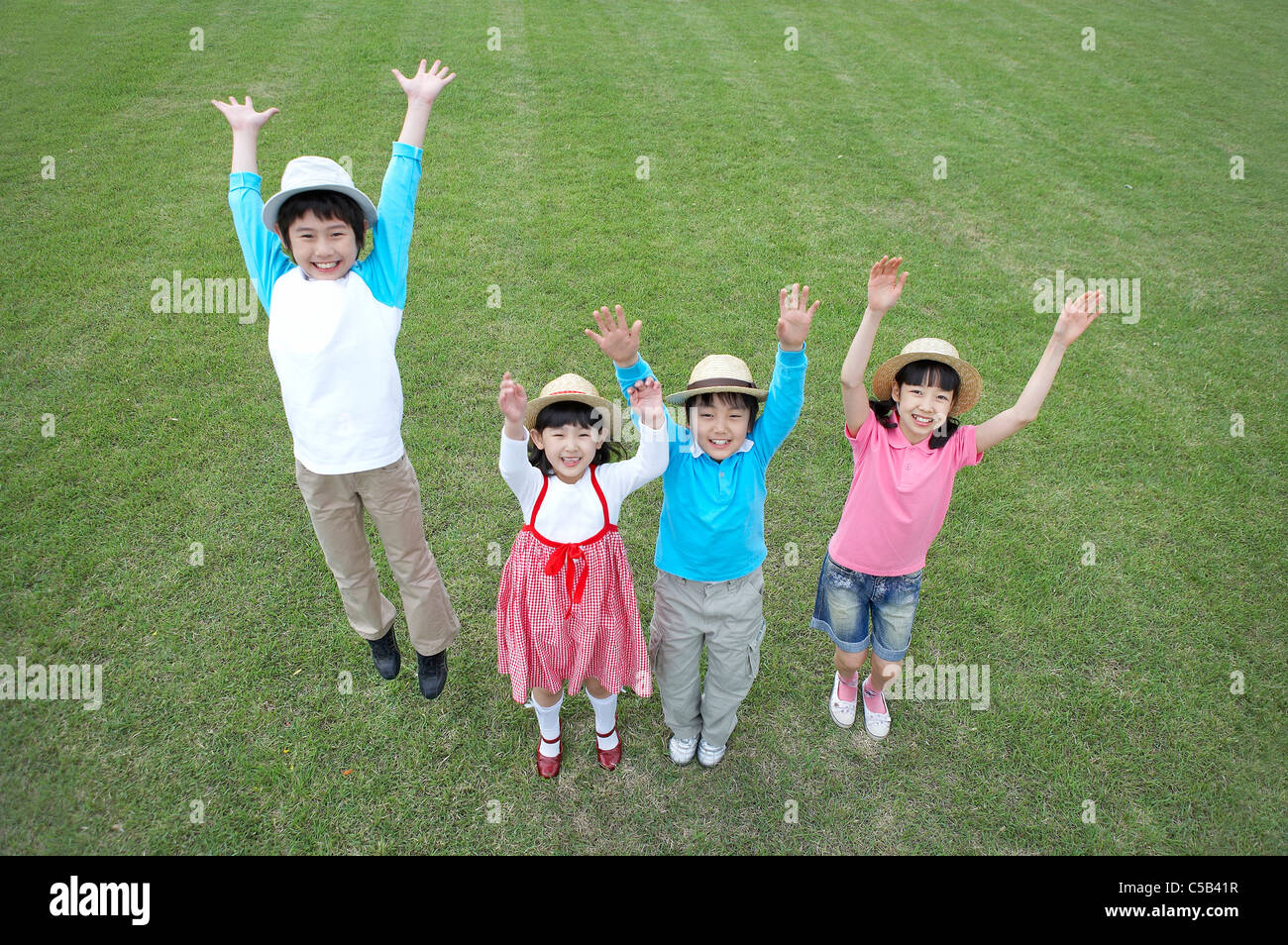 Portrait of children playing in lawn Stock Photo - Alamy