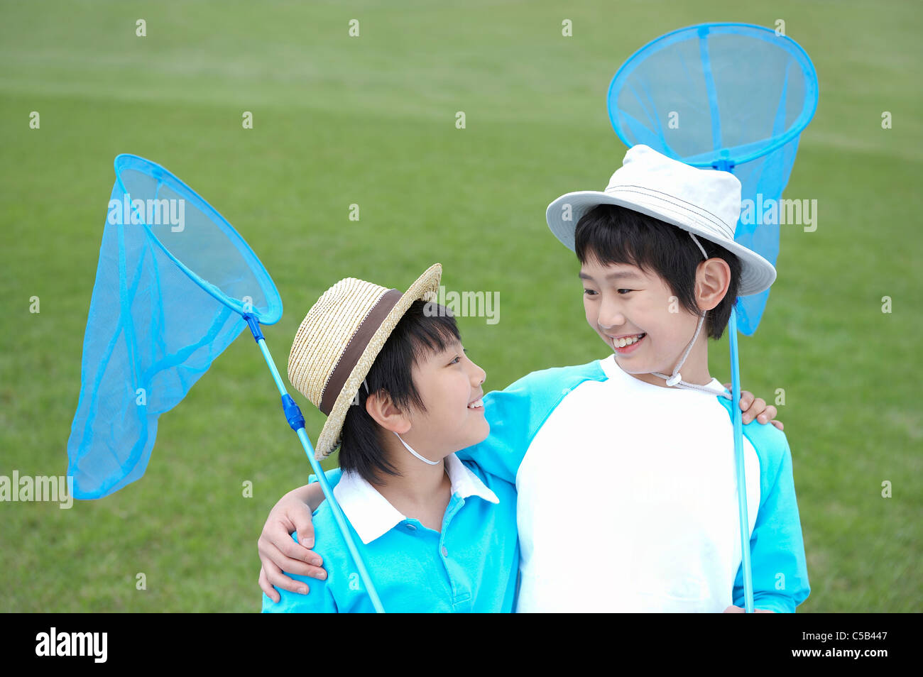 Portrait of boys holding fishing net Stock Photo - Alamy