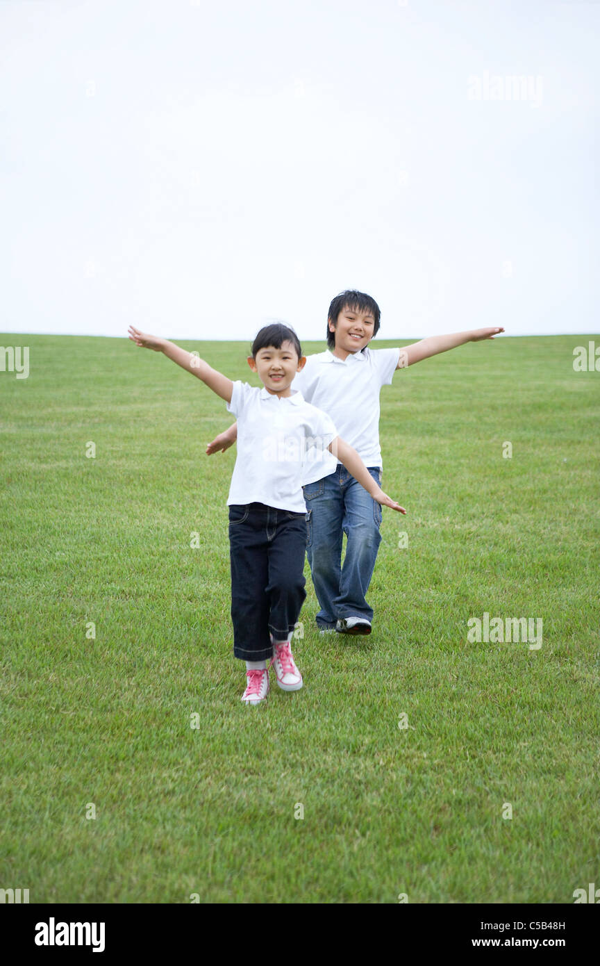 Portrait of children playing in lawn Stock Photo - Alamy
