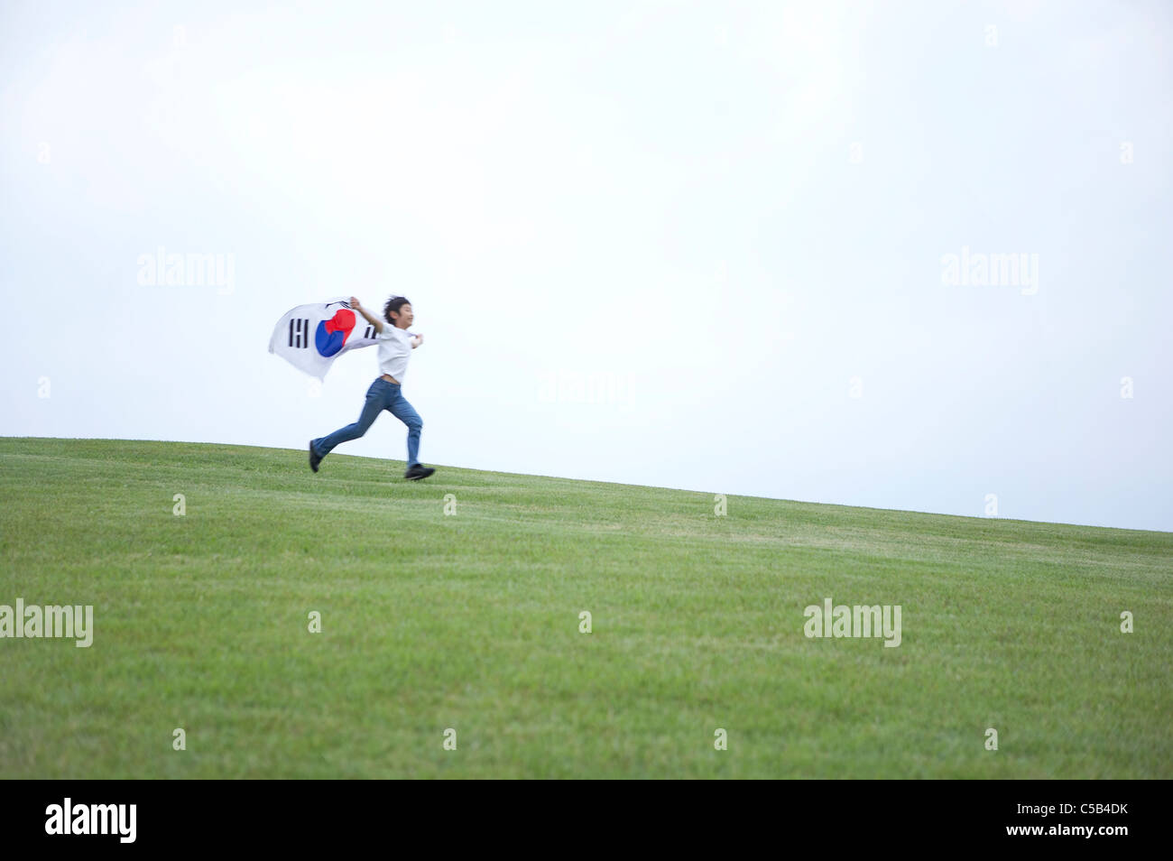 Side view boy running flag hi-res stock photography and images - Alamy