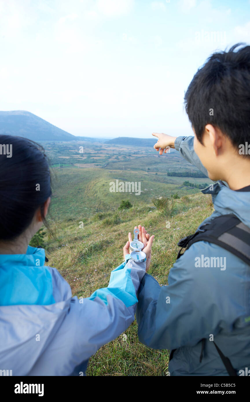 Rear view of Couple holding compass Stock Photo - Alamy