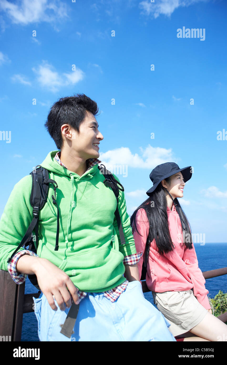 Couple standing by railing Stock Photo - Alamy