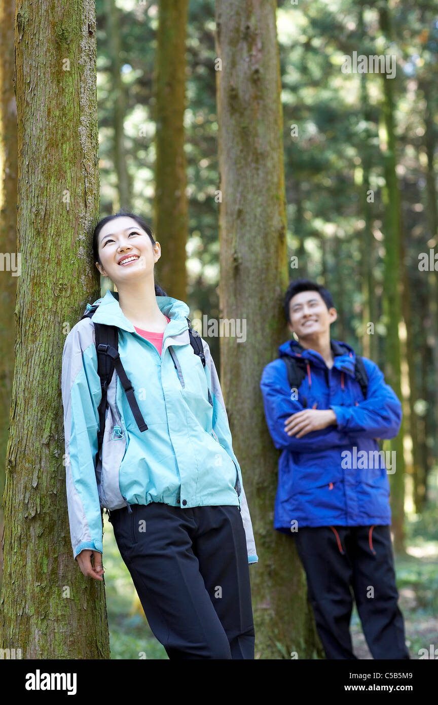 Couple leaning on tree Stock Photo - Alamy