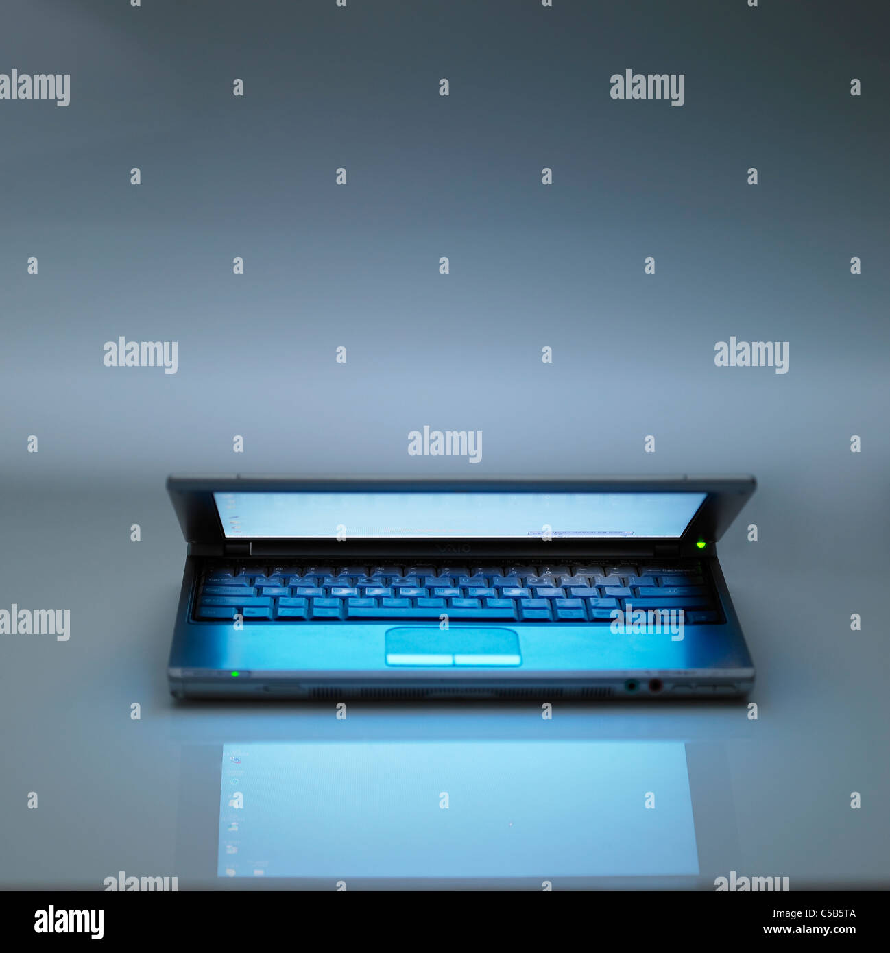 Close-up of partially open laptop on table Stock Photo - Alamy