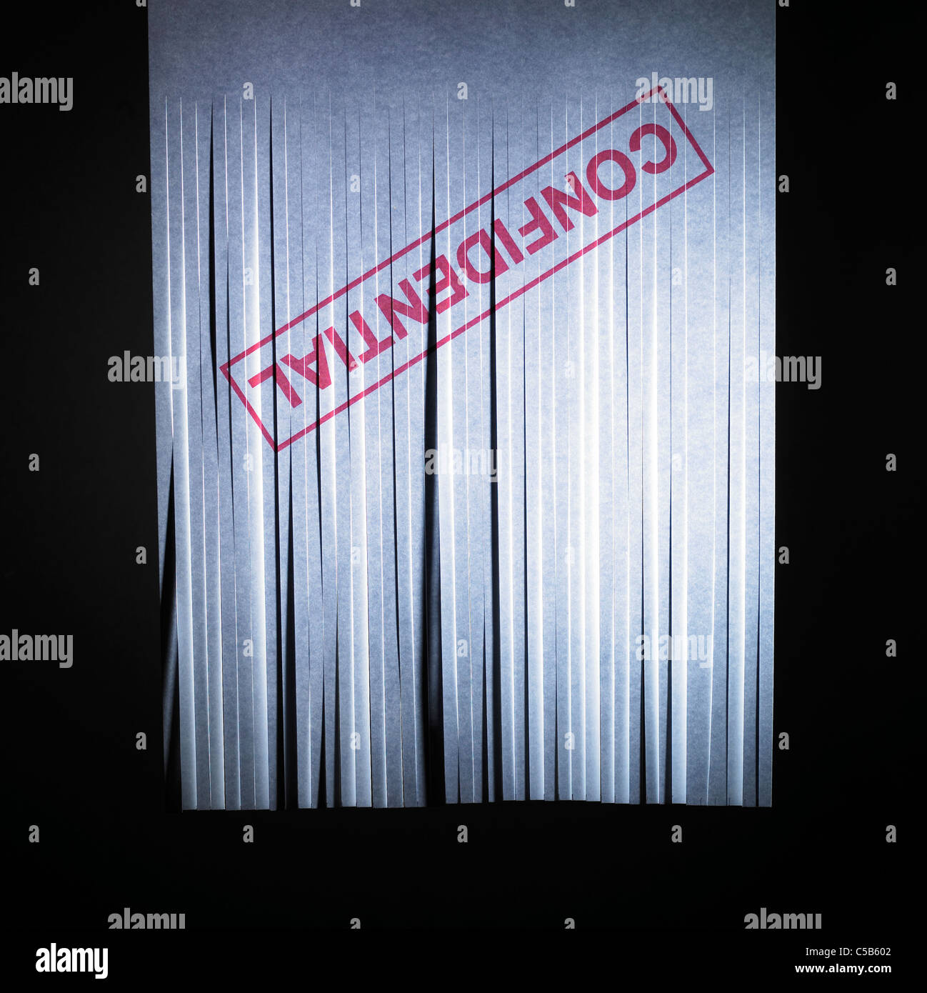 Close-up of Paper with confidential sign being shredded Stock Photo - Alamy