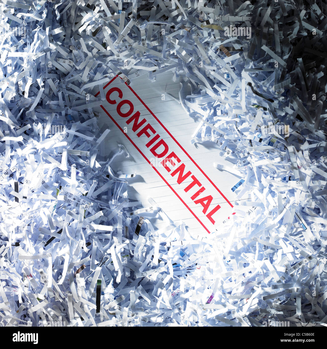 Confidential on paper by shredded paper Stock Photo - Alamy