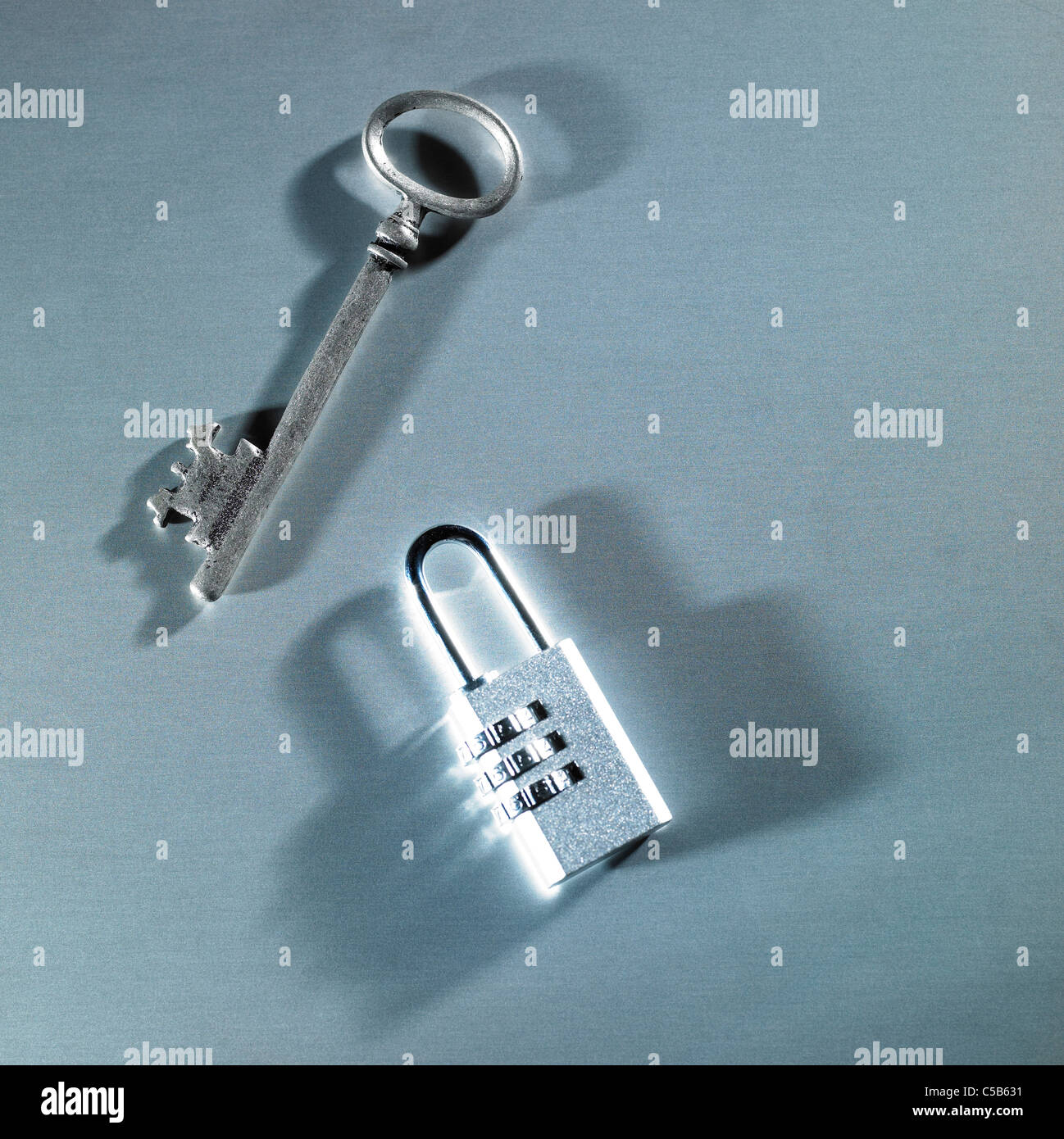 Close-up of key and padlock on table Stock Photo - Alamy