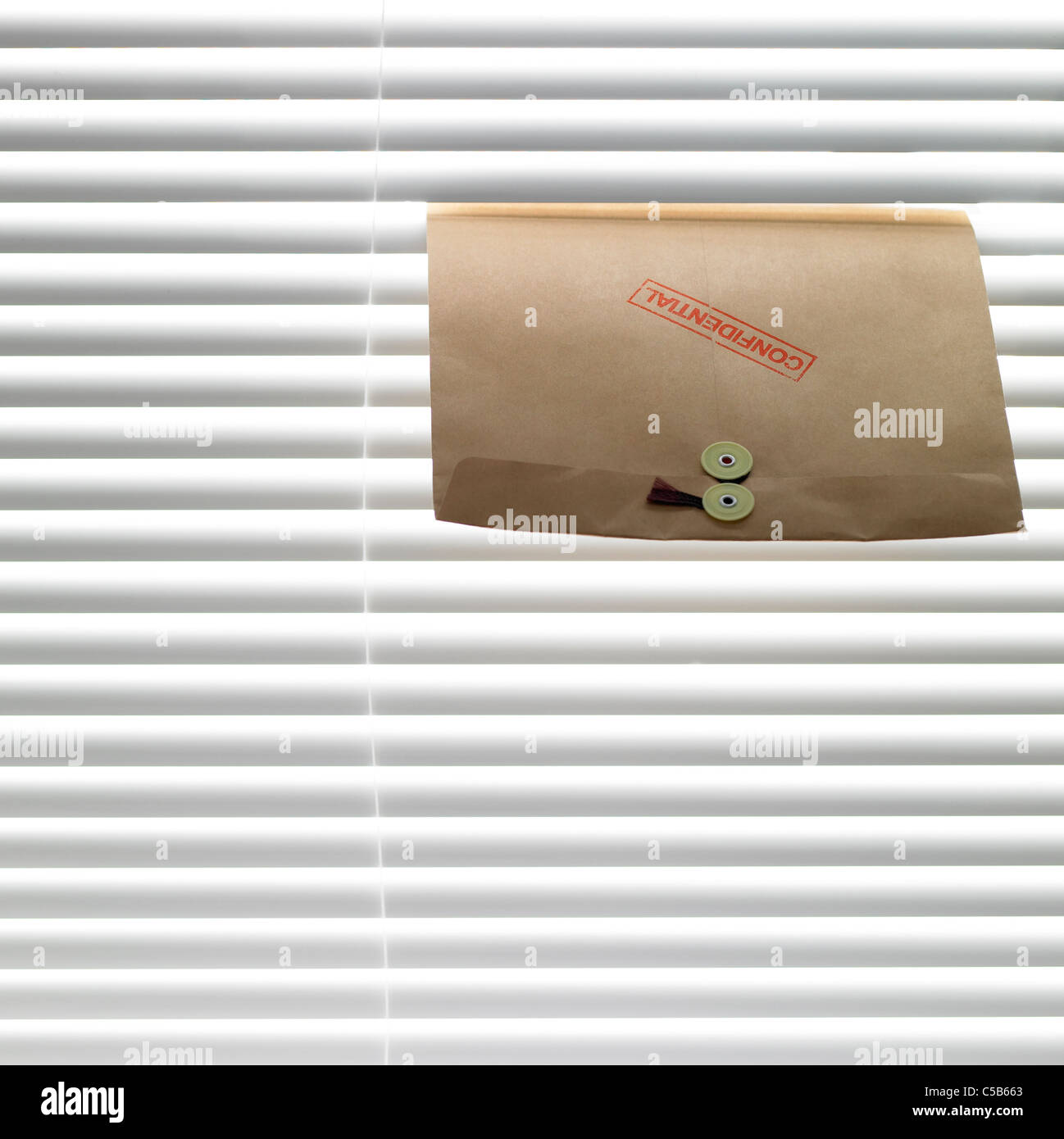 Document through blinds Stock Photo - Alamy