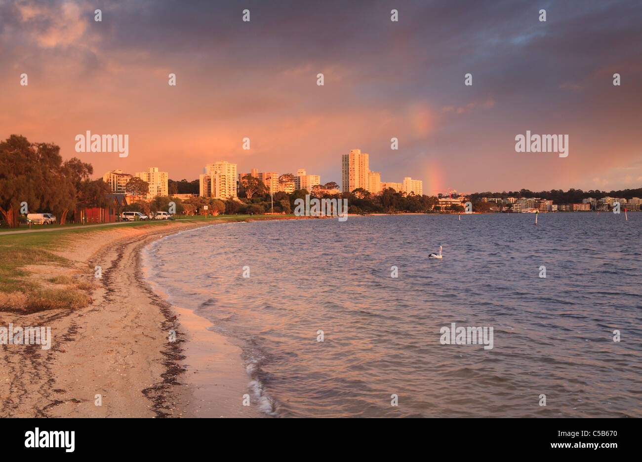 A rainbow at sunrise over South Perth and the Swan River Stock Photo ...