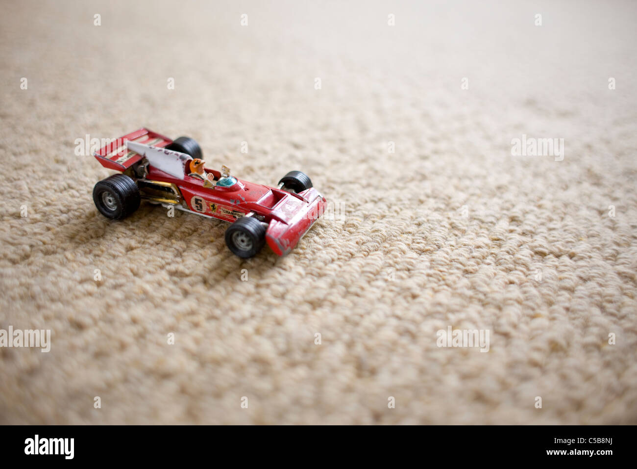 Toy racing car on carpet Stock Photo - Alamy