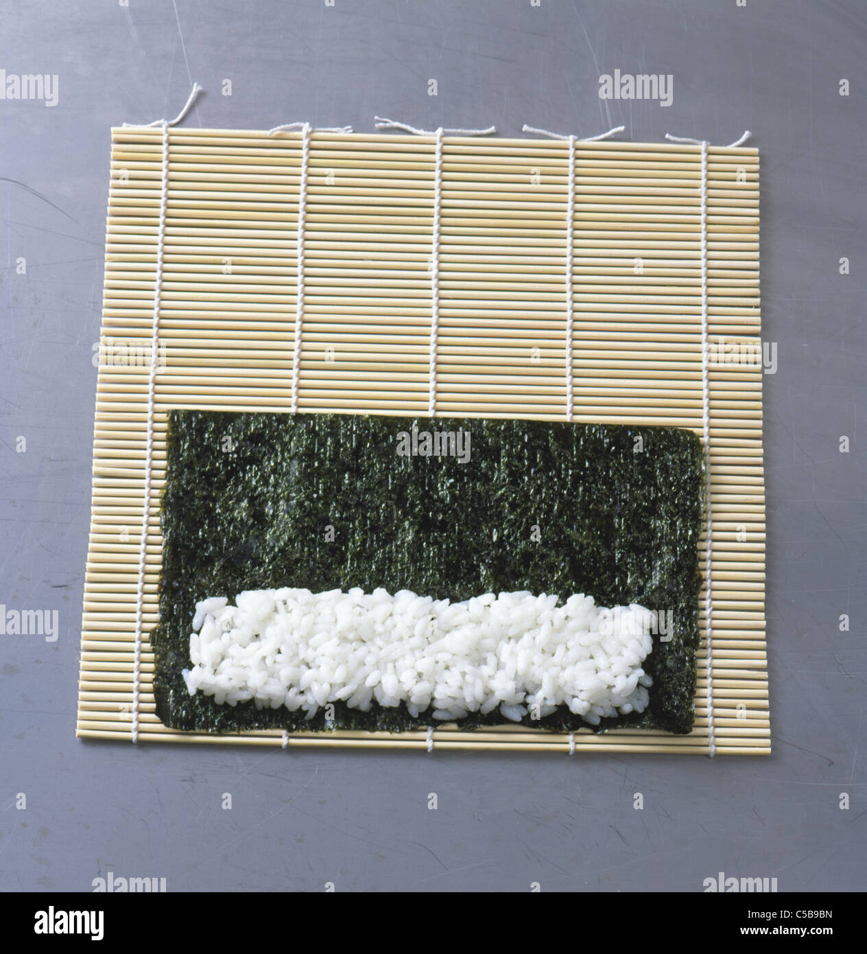 Laying sushi rice on the nori leaf hi-res stock photography and images ...