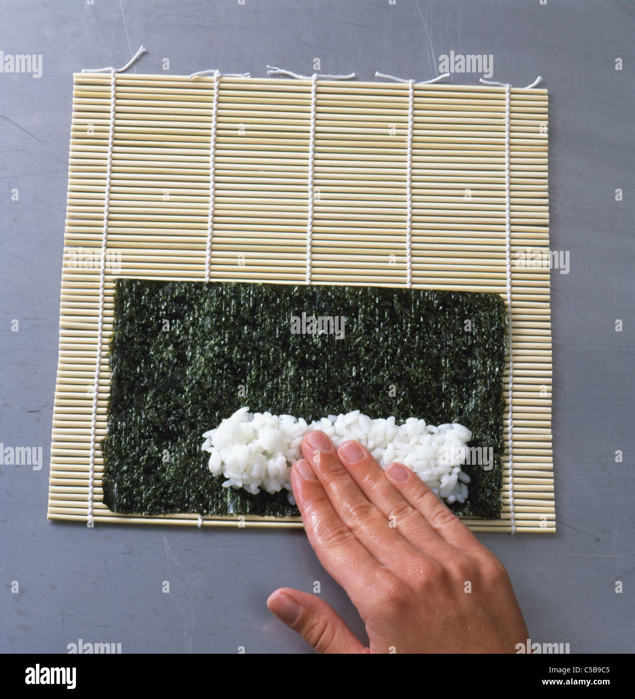 Hosomaki Step: Laying sushi rice on the nori leaf Stock Photo - Alamy
