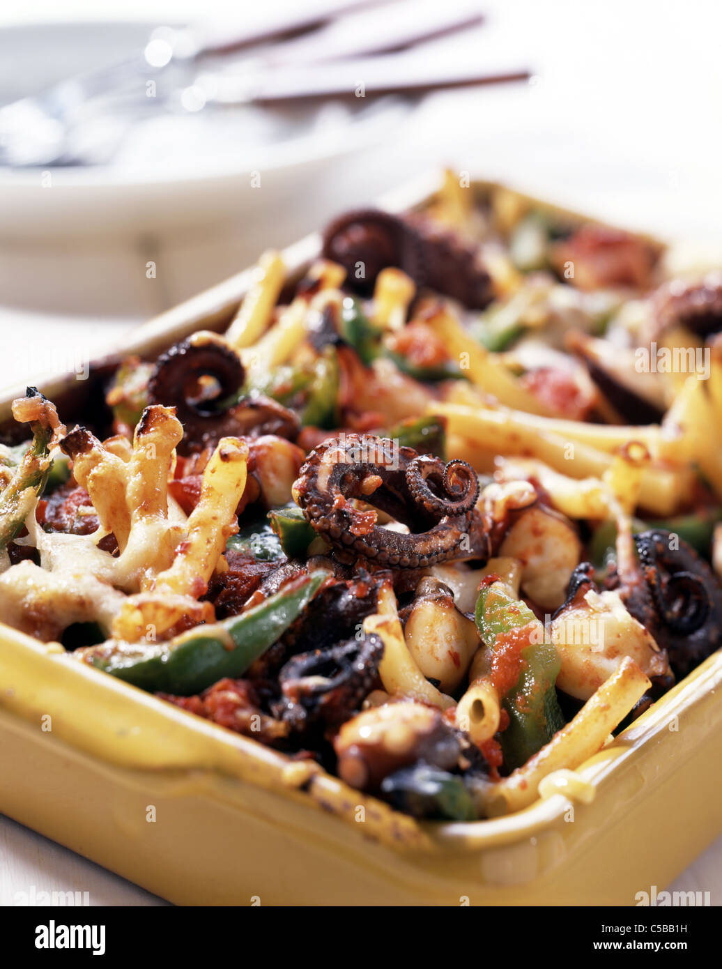 Pasta gratin with octopus Stock Photo - Alamy