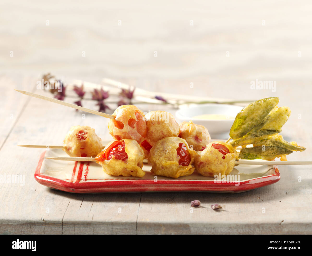 Deep fried tomato skewer on a plate Stock Photo - Alamy
