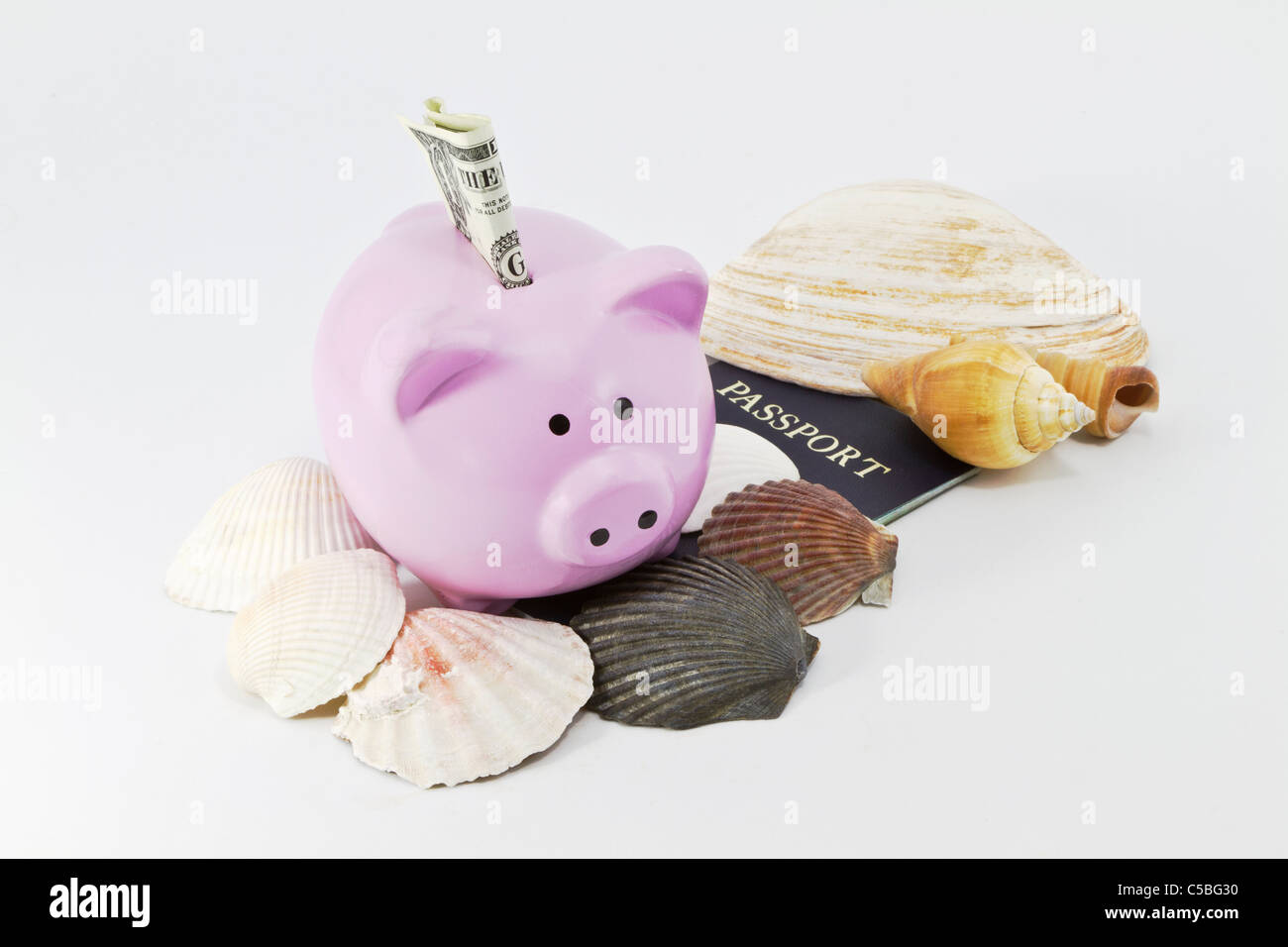 Pig-shaped bank with sea shells and passport reflect savings for summer ...