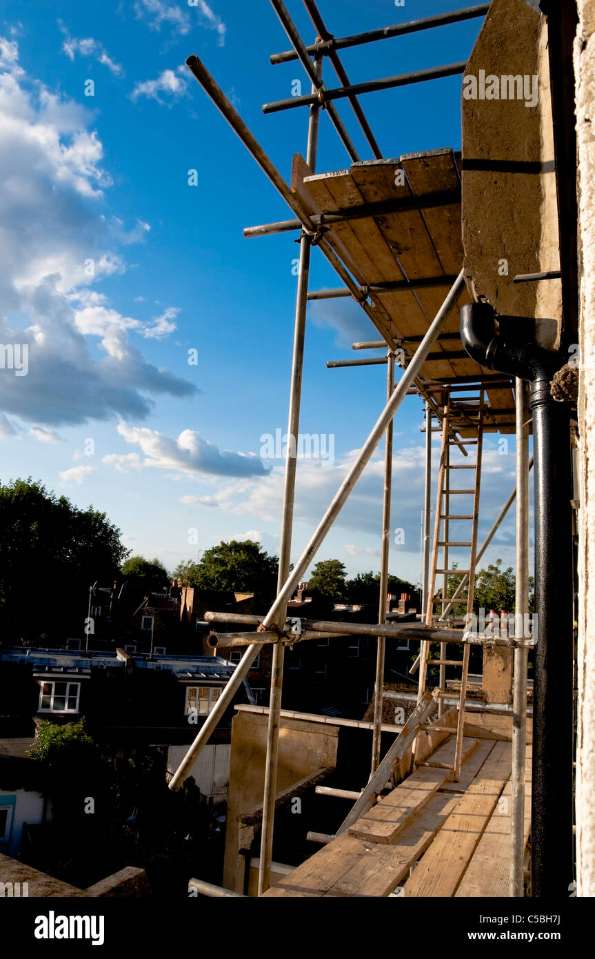 Scaffolding to renovate an old British house Stock Photo - Alamy