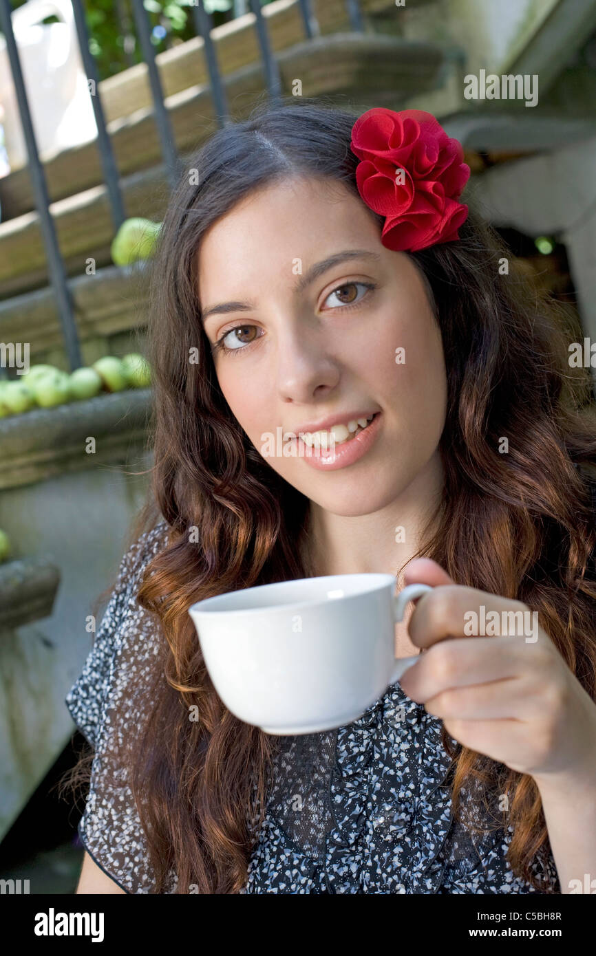 young woman drinking tea in the garden Stock Photo - Alamy