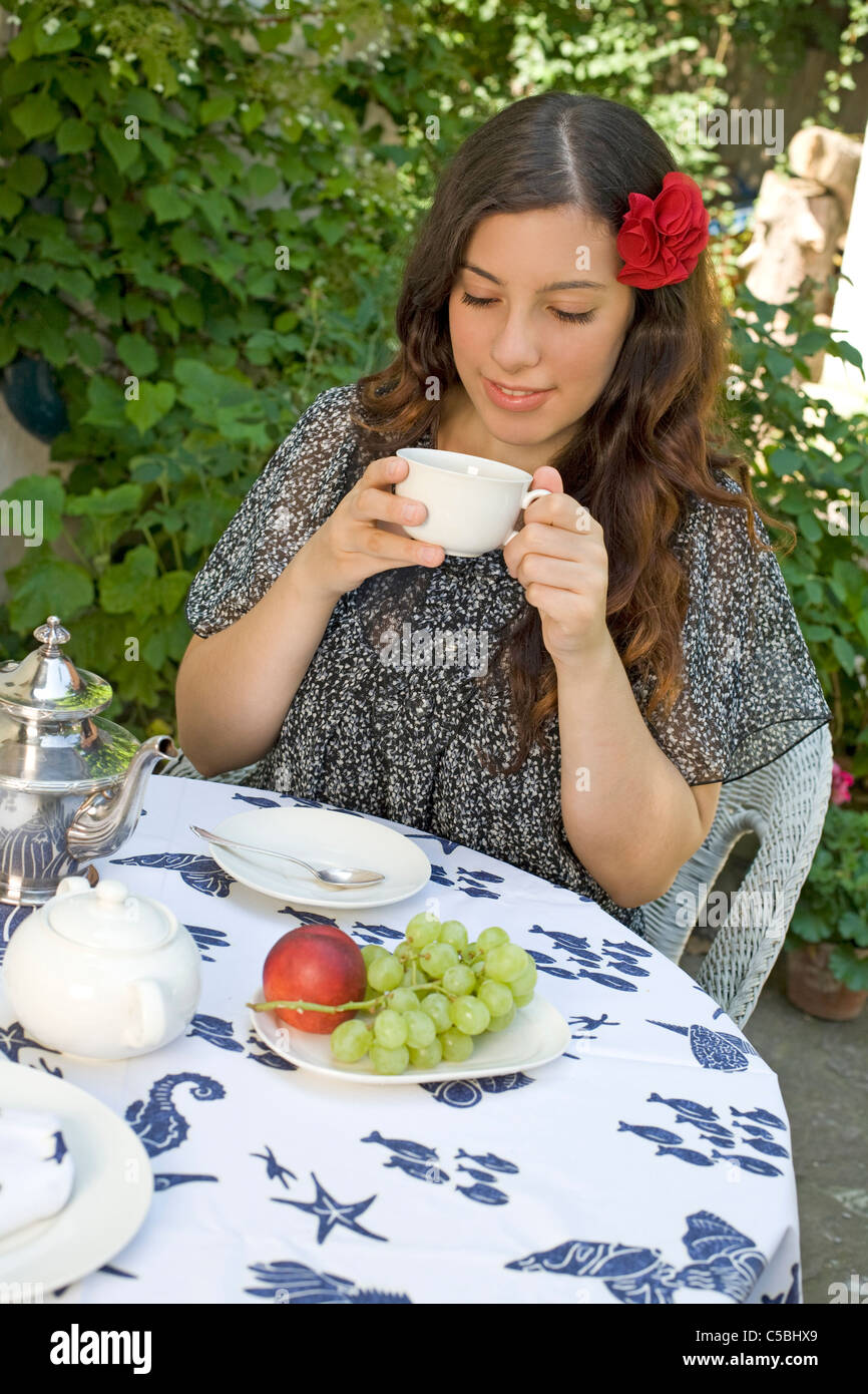young woman drinking tea in the garden Stock Photo - Alamy